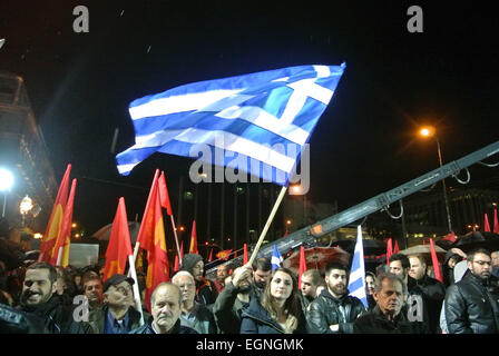 Athens, Greece. 27th February, 2015. A KKE supporter waves a red flag ...