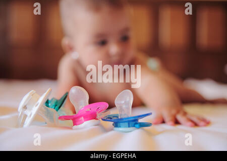 beautiful baby want to take her pacifiers Stock Photo - Alamy