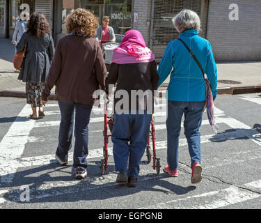 Woman helping elderly woman crossing the street Stock Photo: 72419057 ...