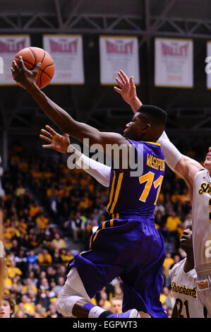 Northern Iowa guard Wes Washpun, right, passes off the basketball while ...