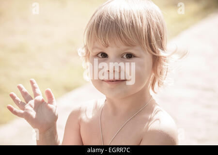 Cute little girl kid saying hi anf how are how by looking at camera on ...