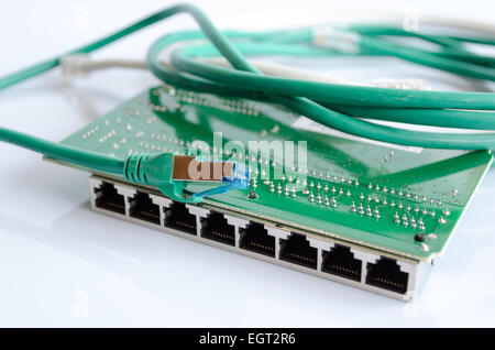 Green network cable and switch on white Stock Photo - Alamy