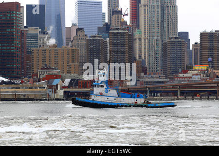 New York East River tugboat, passing Department of Environmental ...