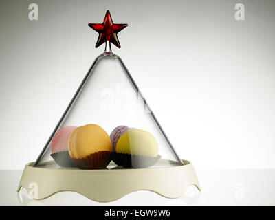 colorful macaron in the triangle glass container with star on top Stock ...