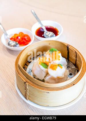 Dimsum set in bamboo container with teapot on black ground Stock Photo ...