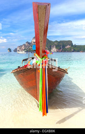 Traditional wooden boat on beautiful tropical beach at sunny morning ...