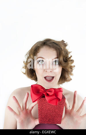 Happy redhead woman open gift box with bow enjoying celebrating holiday ...