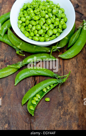 hearthy fresh green peas over a rustic wood table Stock Photo - Alamy