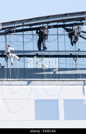 Men working on side of building Stock Photo - Alamy
