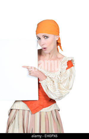 An old woman dressed in rags carrying a bowl in her left hand and a ...