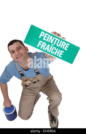 Painter with a 'Peinture Fraiche' sign Stock Photo - Alamy