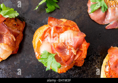 Tapas with fried bacon, tomato and spices Stock Photo - Alamy