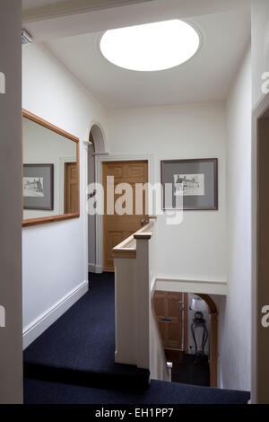 Circular lightwell in blue landing corridor of Macclesfield townhouse ...
