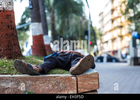 homeless man sleeping under tree, chinatown, bangkok, thailand Stock ...
