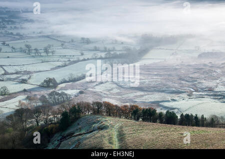 Mist over Castleton in the Peak District on an early winter morning ...