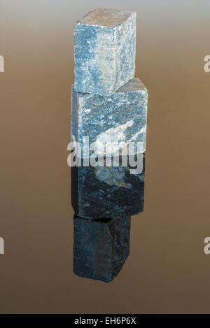 Macro of the surface two cube-shaped stones isolated on white ...