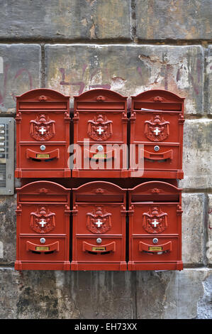 Rows of red metal vintage post office boxes on a wall in the post ...