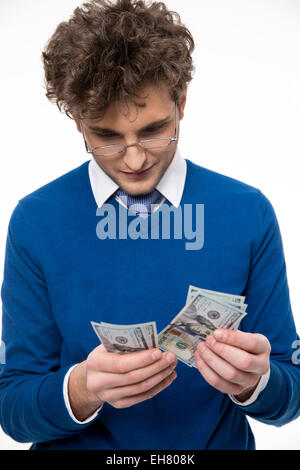 Handsome successful business man counting money, rejoicing and smiling ...