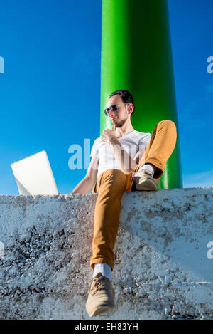 man working outdoors with laptop. Green spring mountain landscape Stock ...