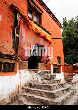 Buddhist monastery gompa or gumba in Chiwang village with prayer flafs ...