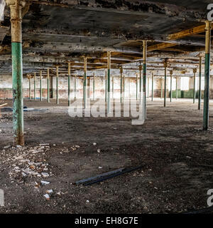 Derelict empty warehouse with debris on the floor Stock Photo - Alamy