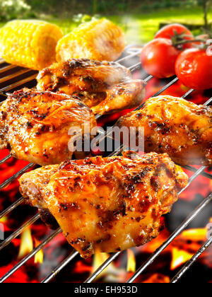 Barbecue chicken pieces cooking on a bbq over flames Stock Photo - Alamy