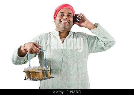 1 indian man Tea Servant Selling Tea and talking Mobile Phone Stock ...