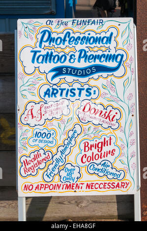 A sign for a tattoo and piercing parlour Stock Photo - Alamy