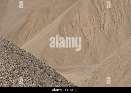 Detail of piles of gravel mined from limestone at a quarry near Stock ...