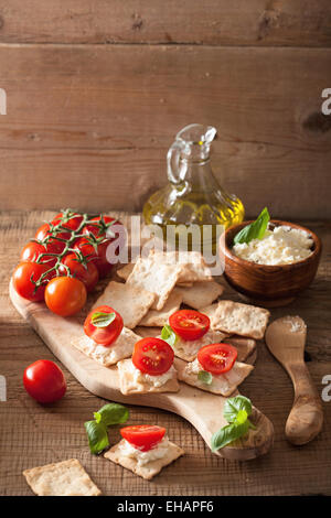 Soft cheese with tomatoes and cracker Stock Photo - Alamy