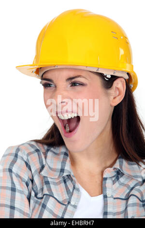 Female builder shouting Stock Photo - Alamy