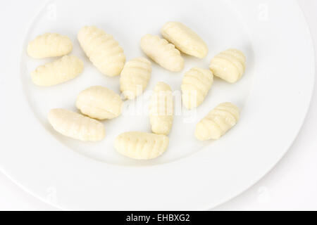 uncooked gnocchi noodles on a plate Stock Photo - Alamy