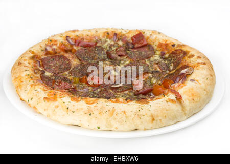 Hot supreme pizza on white wooden table with tomatoes and basil flat ...