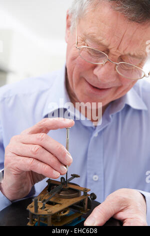 patient man repairing a watch at home Stock Photo - Alamy