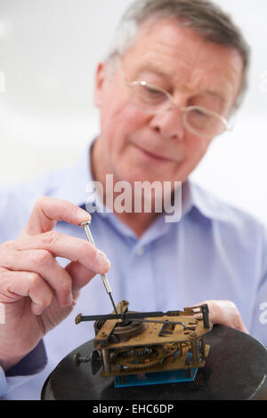 patient man repairing a watch at home Stock Photo - Alamy