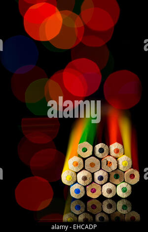 Color pencils with black background an bokeh Stock Photo - Alamy