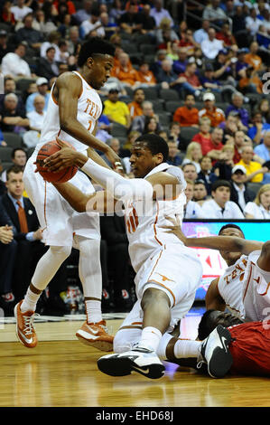 Texas forward Jonathan Holmes (10) jumps over Oklahoma State post ...