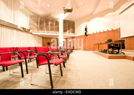 Conference room with red chairs in a row Stock Photo - Alamy