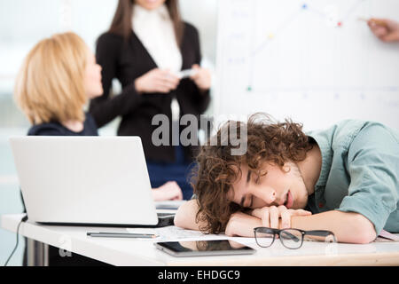 Young businessman sleeping during meeting Stock Photo - Alamy