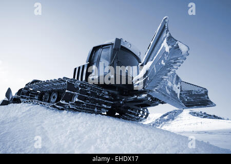 Snow-grooming machine. Snow cat machine making the ski run smooth ...