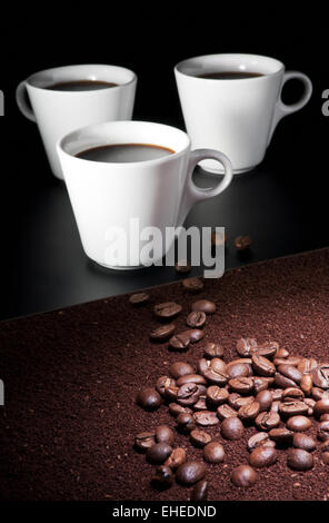 Three cups of coffee: ground coffee (powder), coffee beans and freshly ...