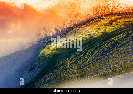 Colored Ocean Wave Falling Down at Sunset Time Stock Photo - Alamy