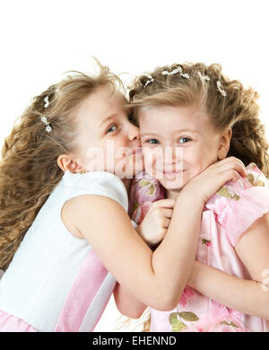 Two cute blond sisters kissing outdoors Stock Photo - Alamy