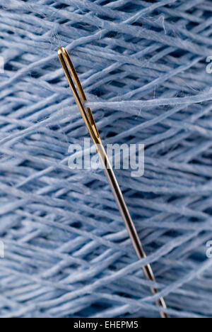 Light blue embroidery thread on white background Stock Photo - Alamy