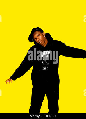 Portrait of Dizzee Rascal against yellow background Stock Photo - Alamy