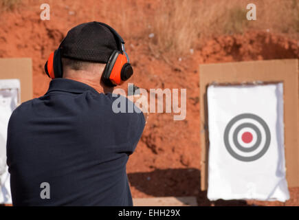 Man shooting on an outdoor shooting range, selective focus Stock Photo ...
