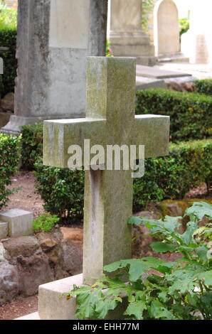 Old and worn tombstone with a Catholic cross Stock Photo - Alamy