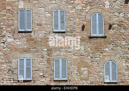 Italian style wooden window with closed shutter blinds on brick wall ...