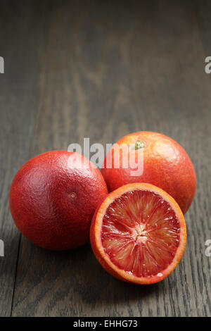 red (bloody) oranges on a wooden plate Stock Photo - Alamy