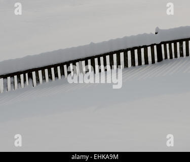 Wooden fence covered with fresh snow in winter Stock Photo - Alamy